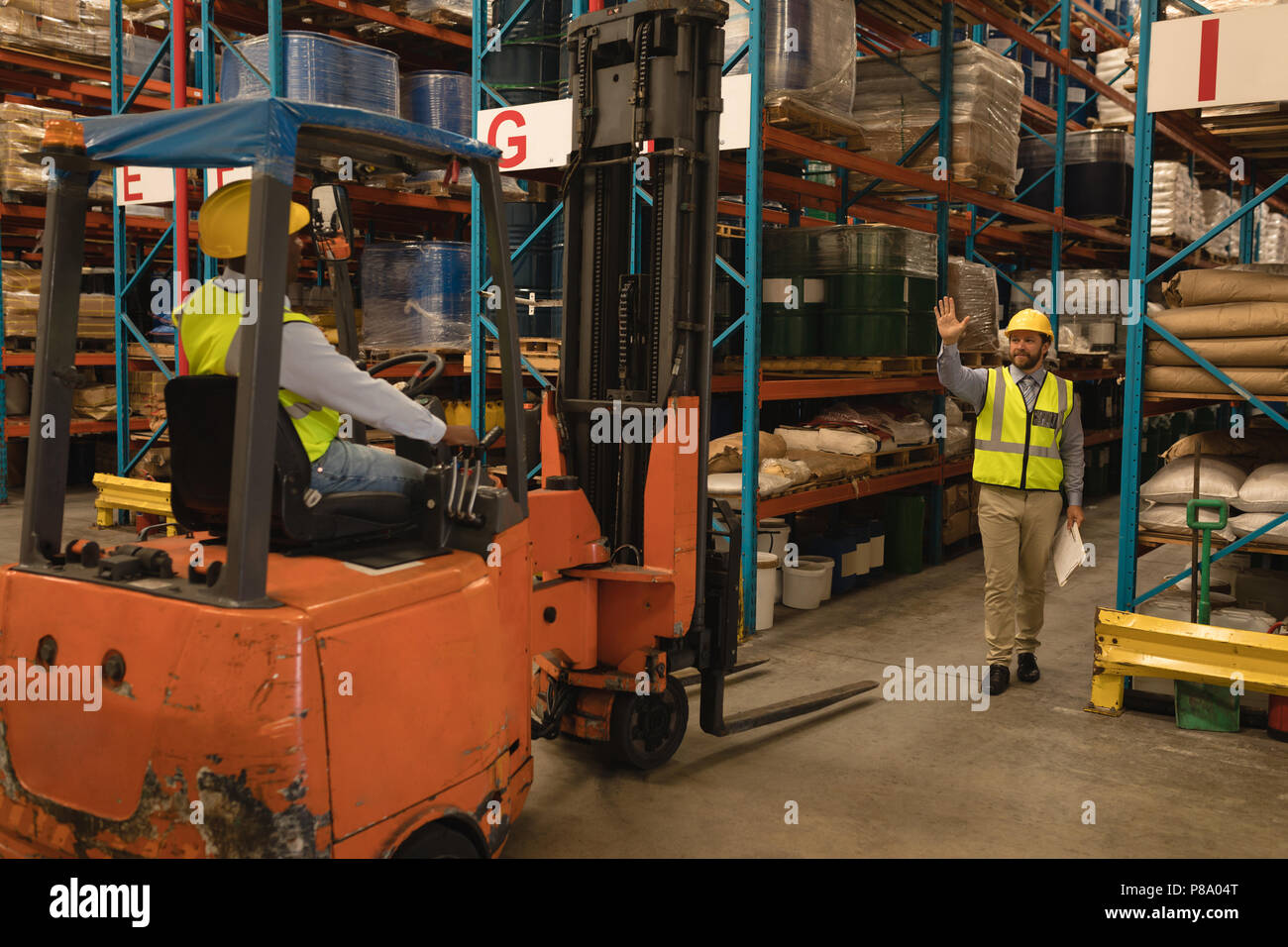 Male workers interacting with each other Stock Photo - Alamy