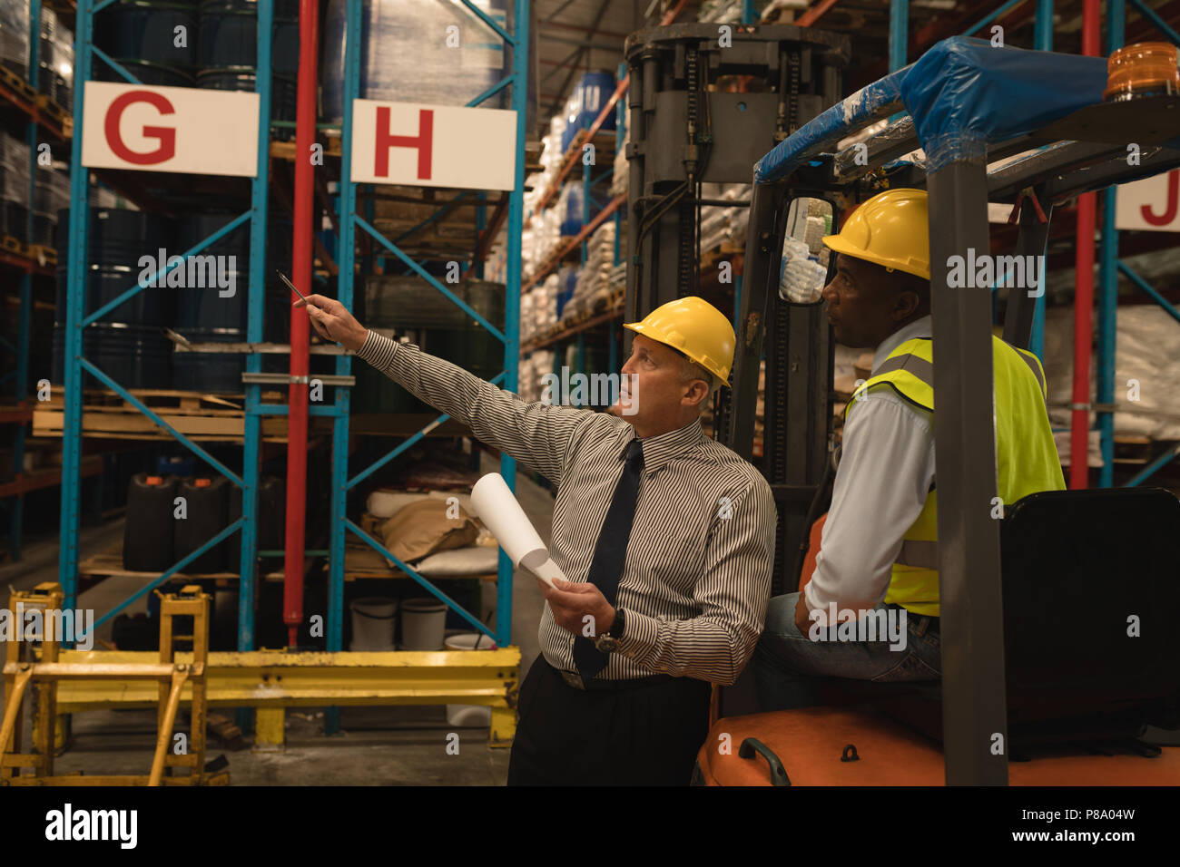 Male workers interacting with each other Stock Photo - Alamy