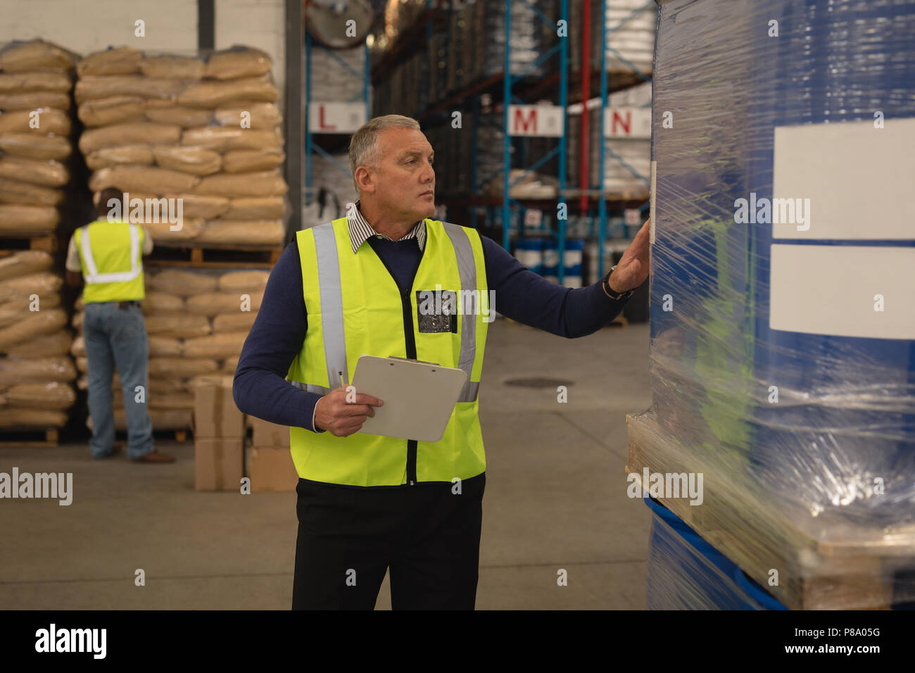 Male supervisor checking stock Stock Photo - Alamy