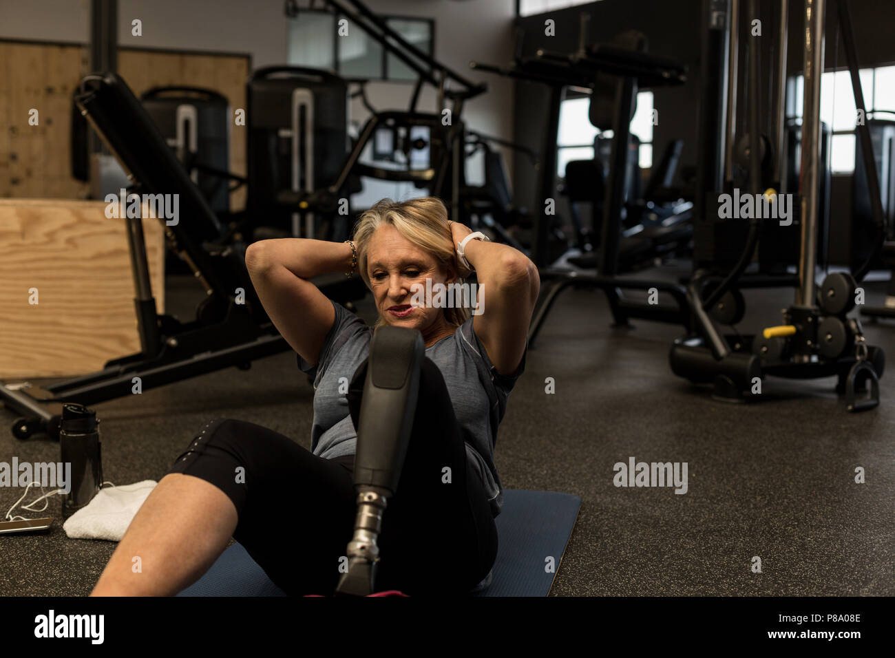 Disabled woman performing stretching exercise Stock Photo - Alamy