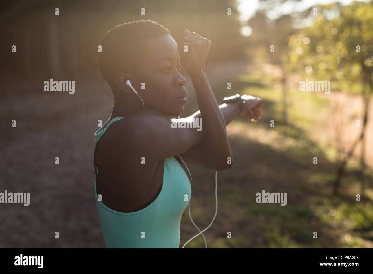 Female athlete listening to music while doing morning workout Stock ...