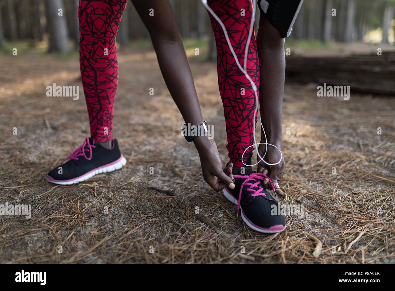 Female athlete tying her shoe lace Stock Photo - Alamy