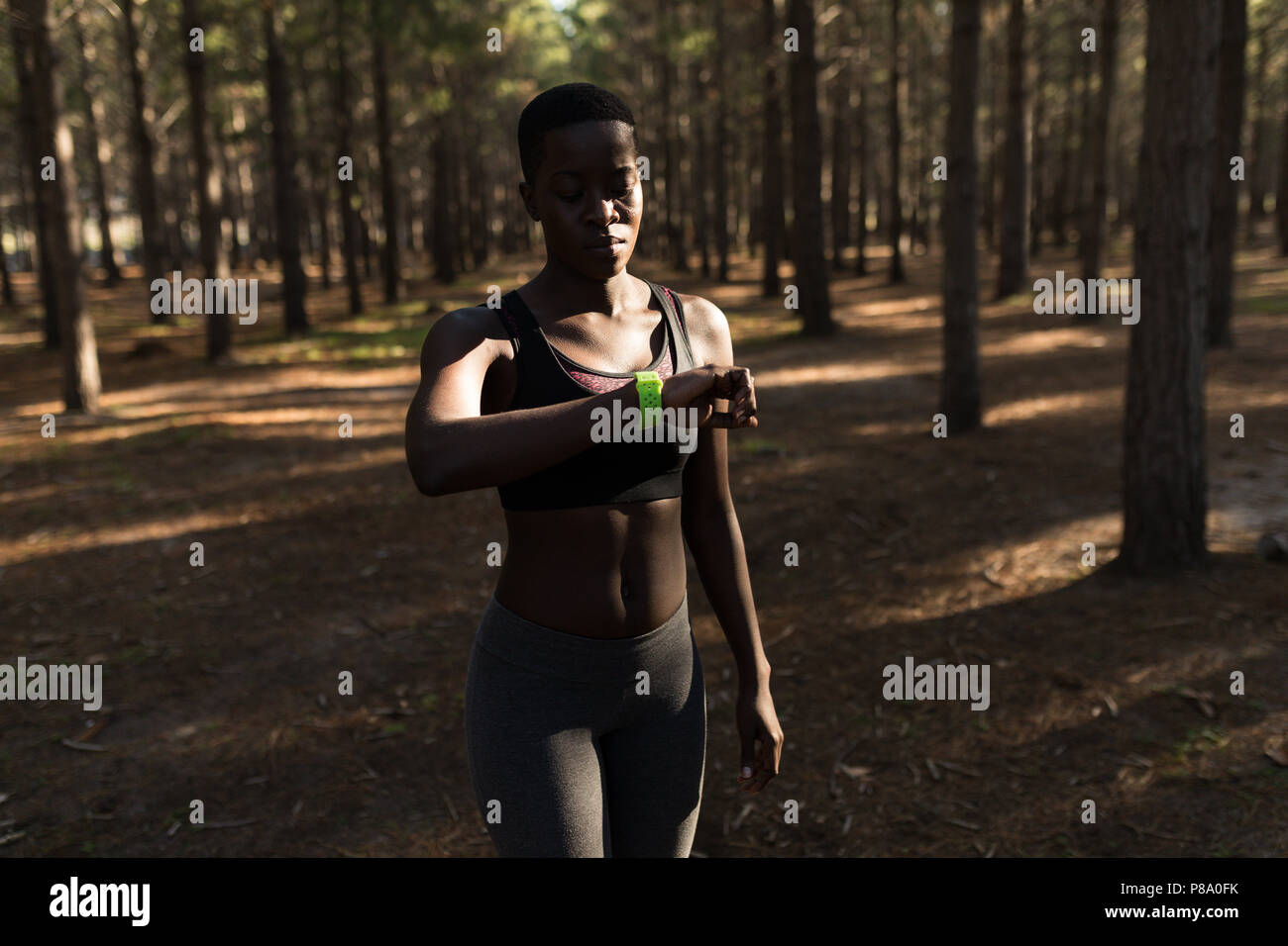 Female athlete checking her smartwatch Stock Photo - Alamy