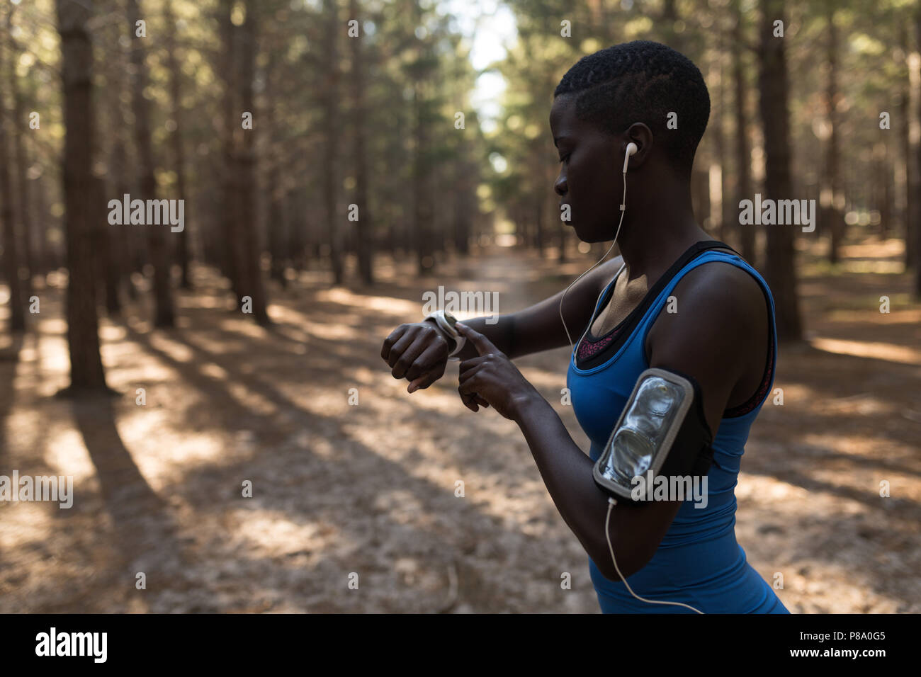 Female athlete checking her smartwatch Stock Photo - Alamy