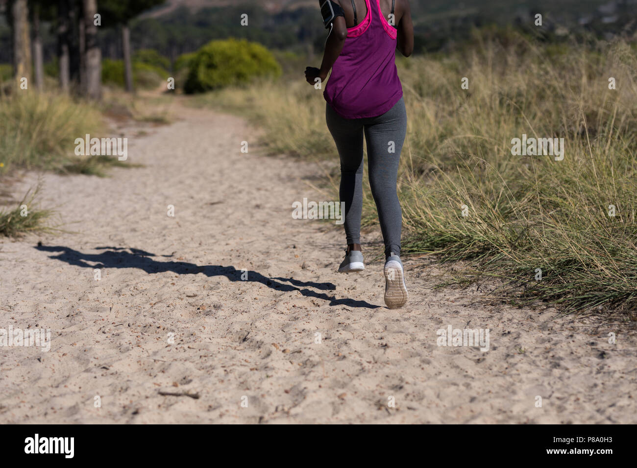 Female athlete running in the forest Stock Photo - Alamy