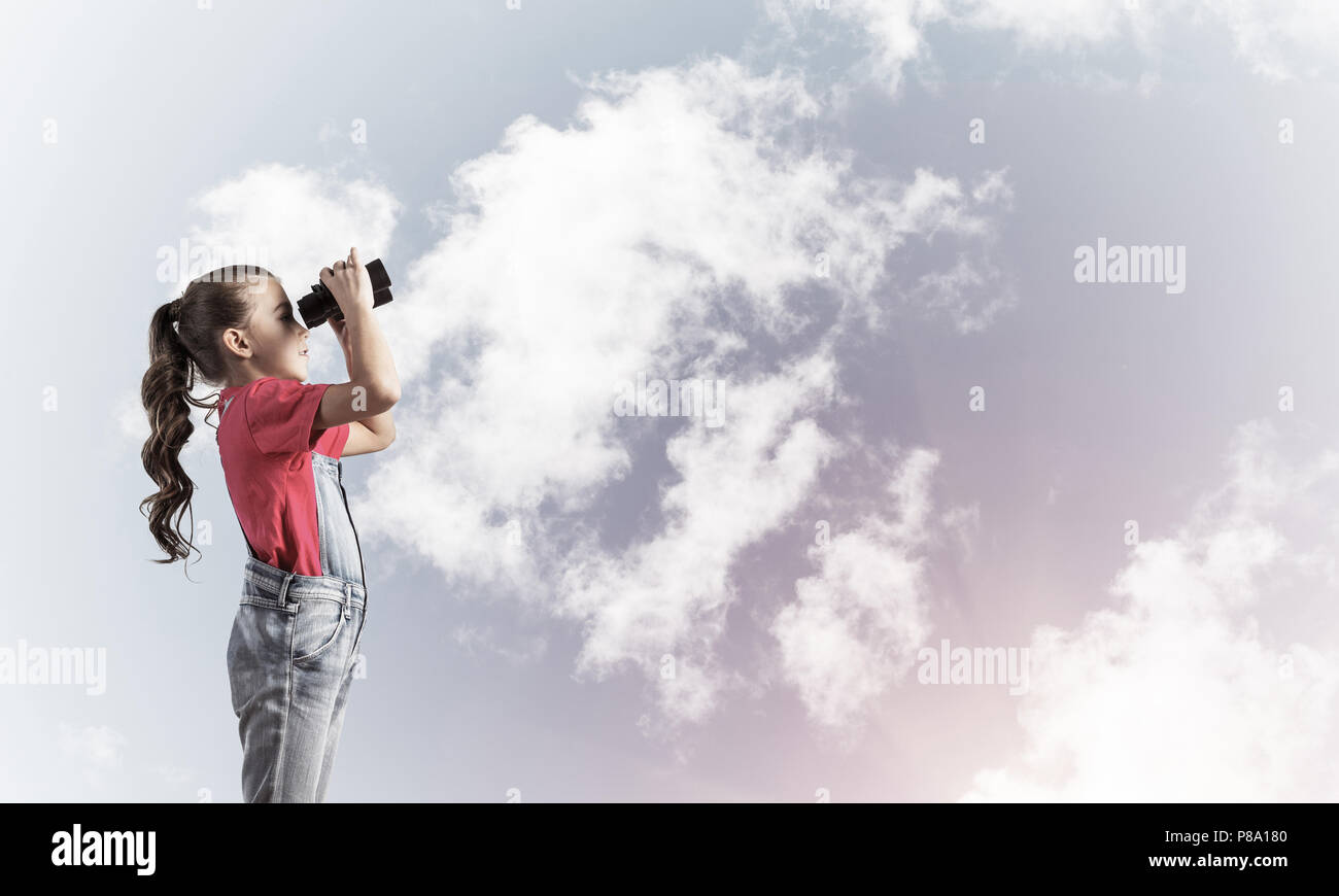 Concept of careless happy childhood with girl looking in binocul Stock ...