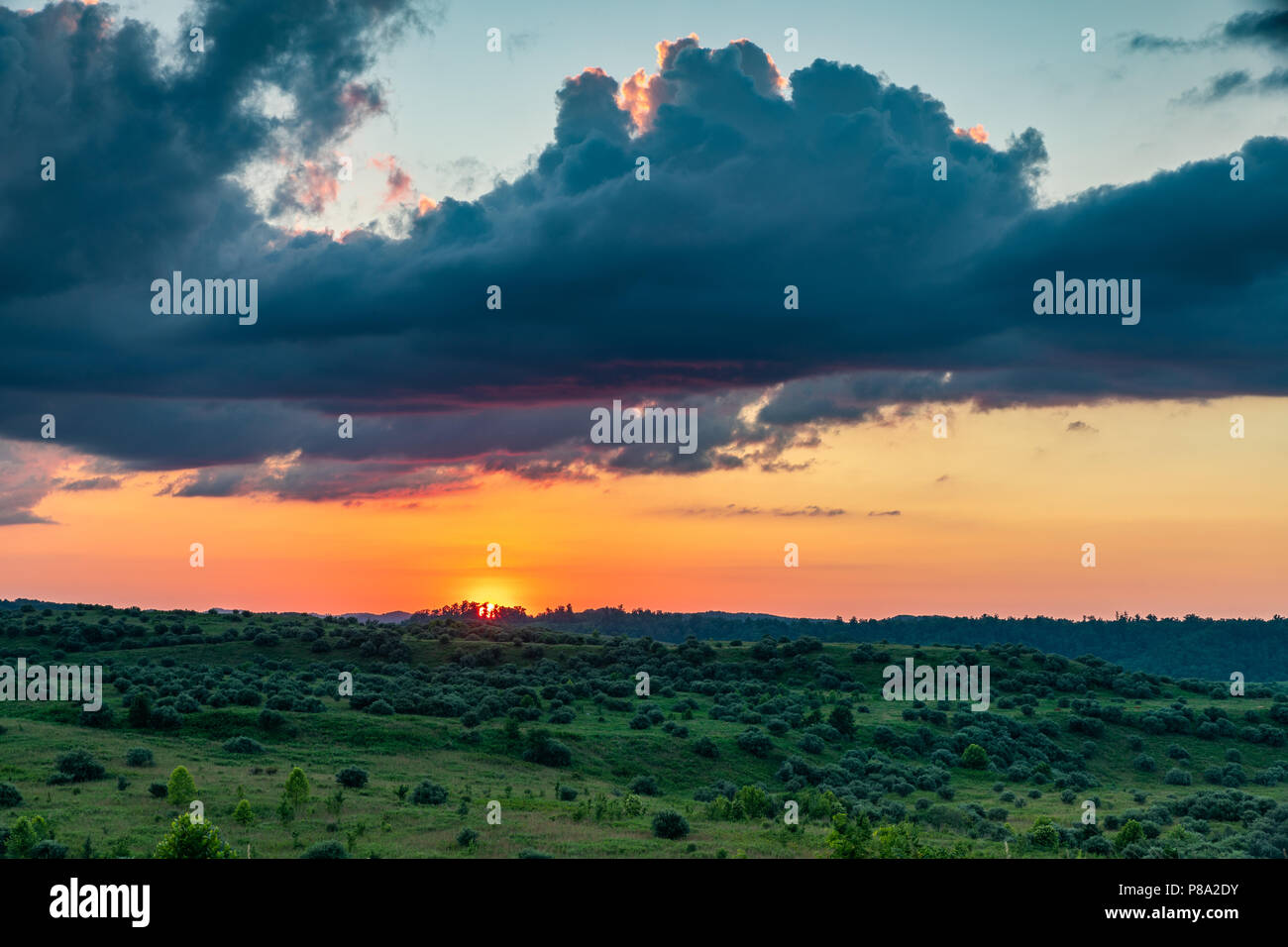 Clouds hover above a sunset on the horizon Stock Photo - Alamy