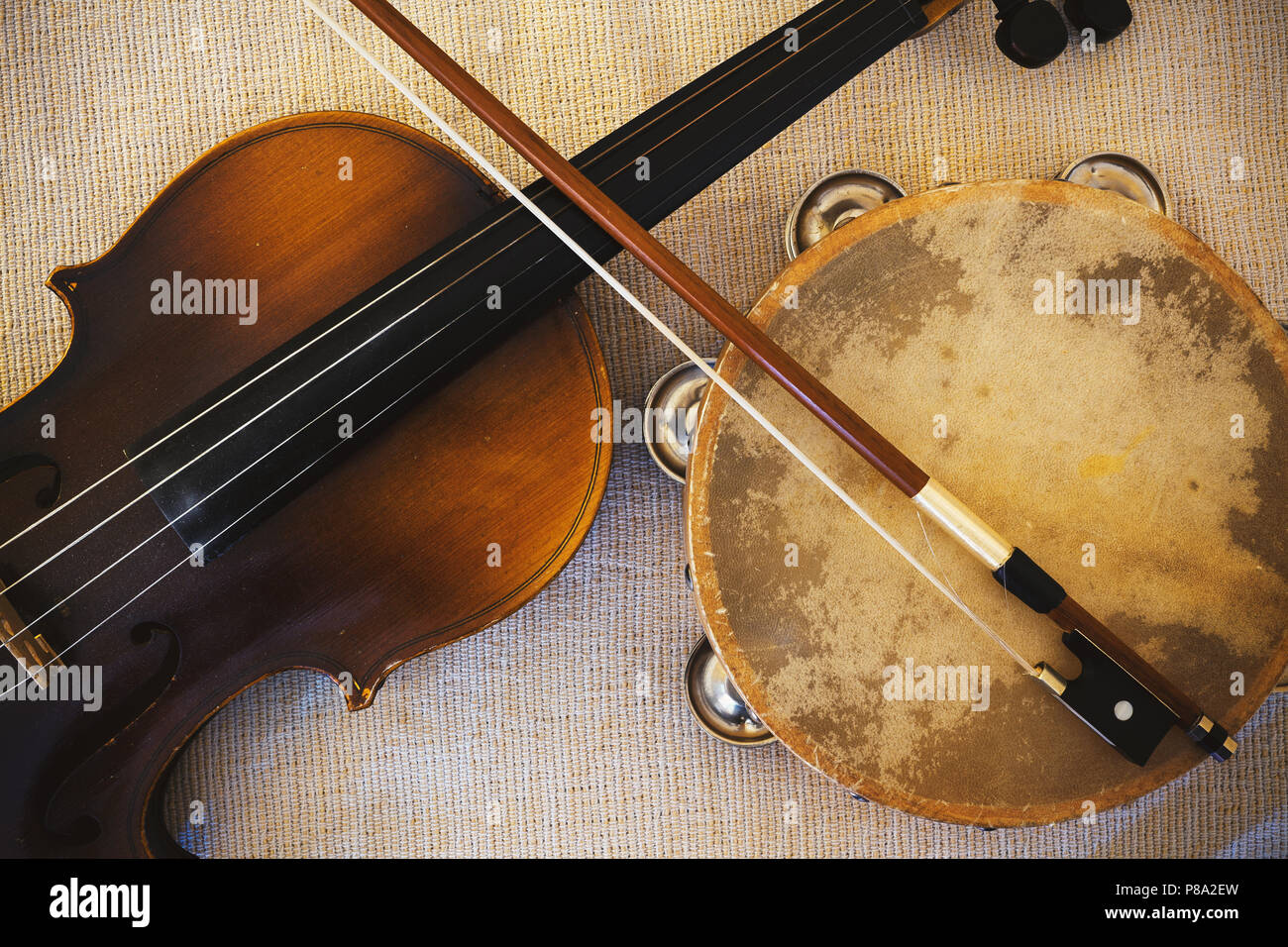 Details of an old and dusty violin from Czechoslovakia and tambourine ...