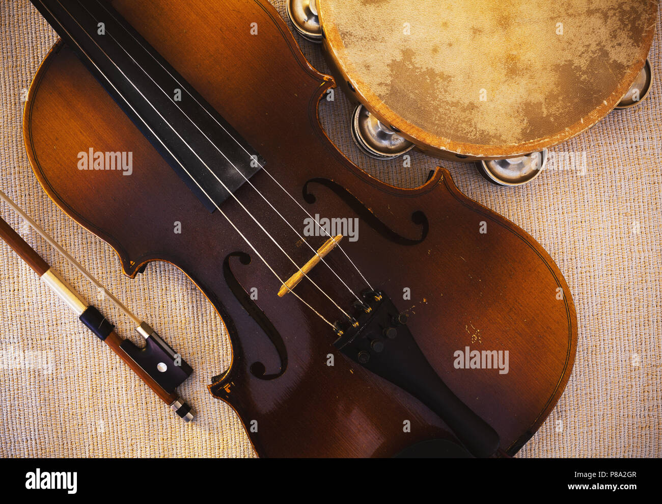 Details of an old and dusty violin from Czechoslovakia and tambourine ...