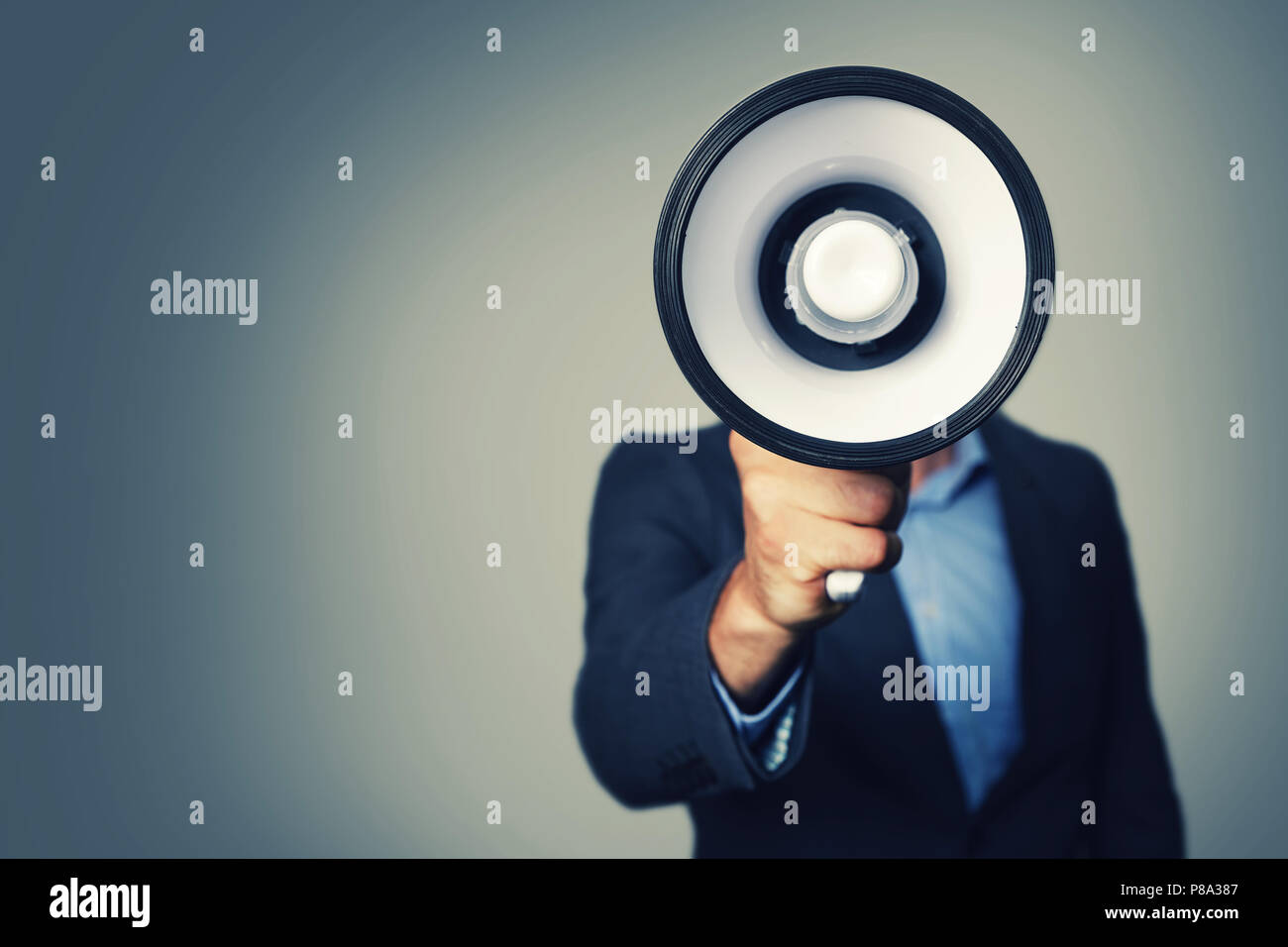 businessman with megaphone in hand in front of face Stock Photo - Alamy