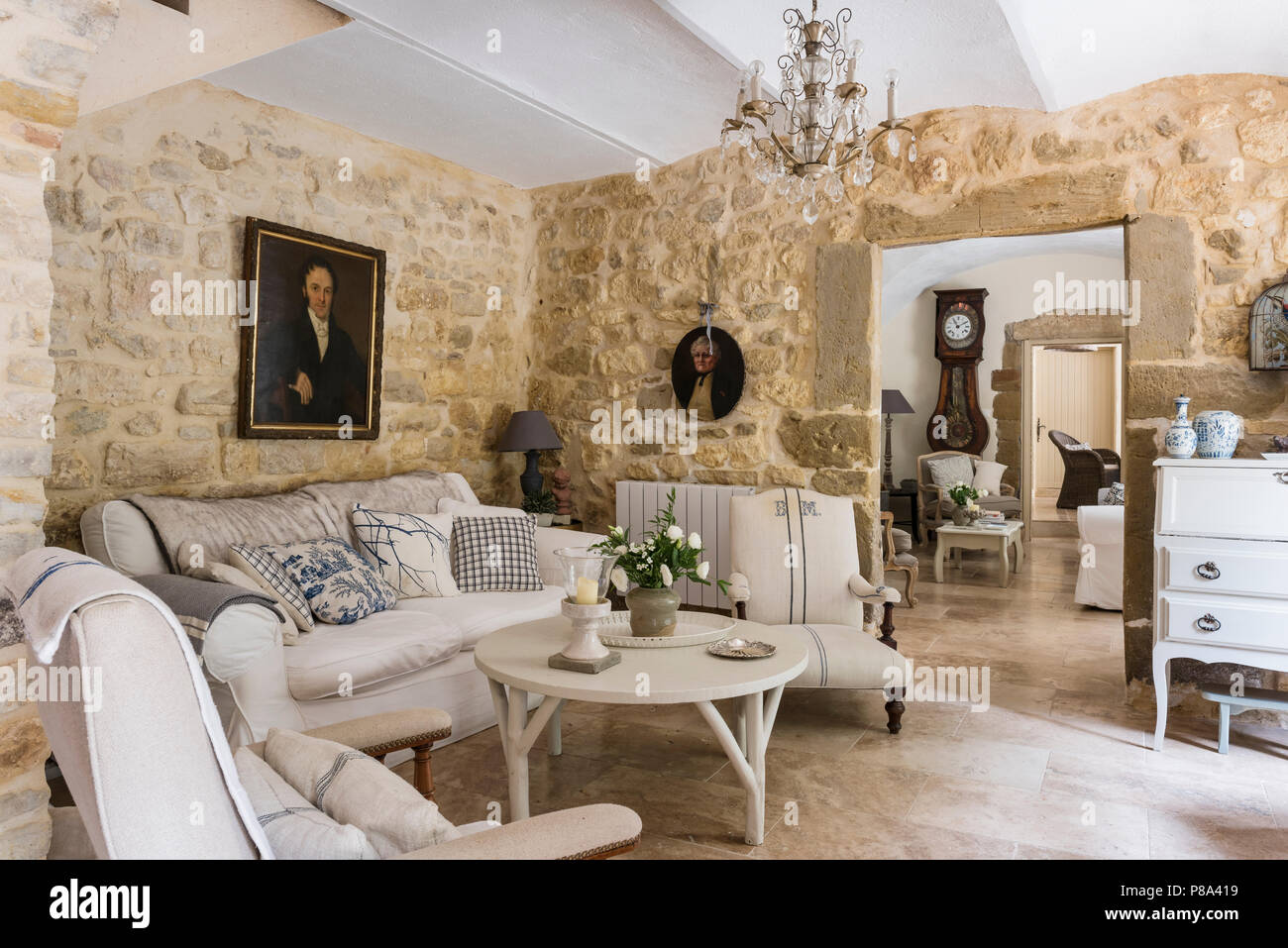 French travertine floors with crystal chandelier and seating area Stock ...