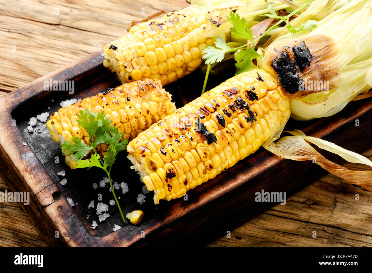 Delicious grilled corn.Fast food in the summer Stock Photo - Alamy