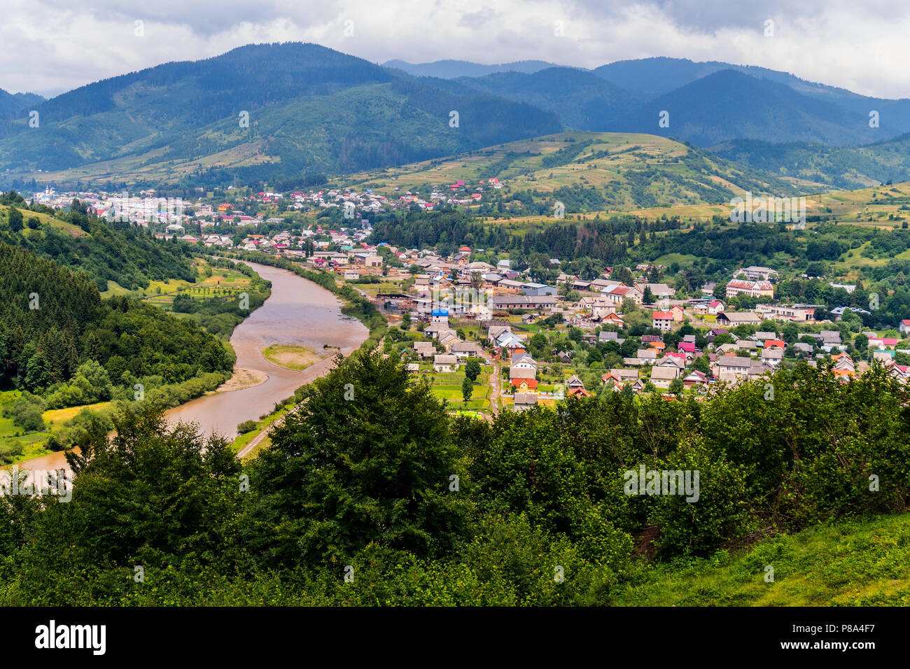 A small rural village, separated by a river canal on one side and a ...