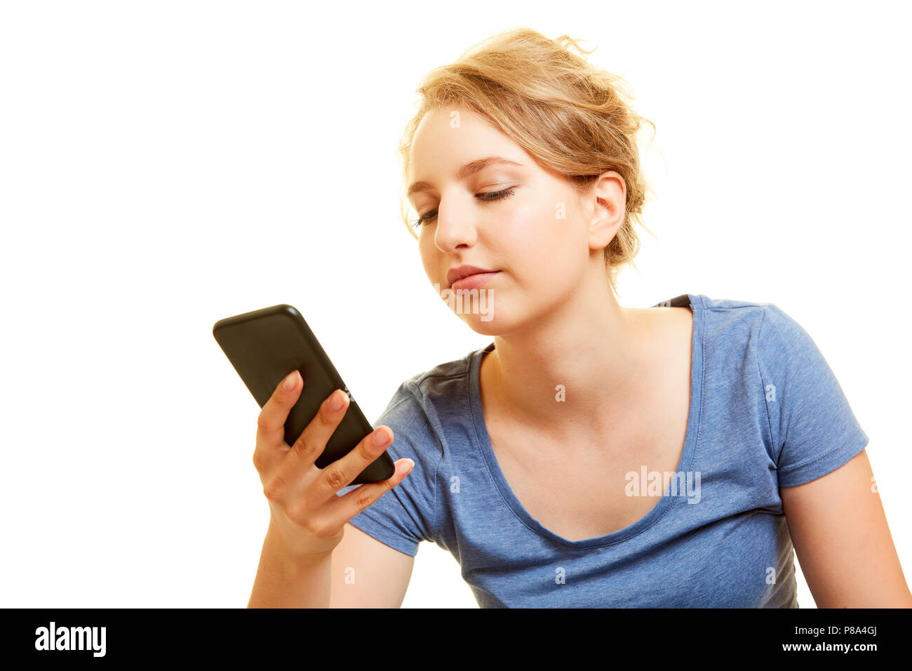 Young blond woman types a chat message on her smartphone Stock Photo ...
