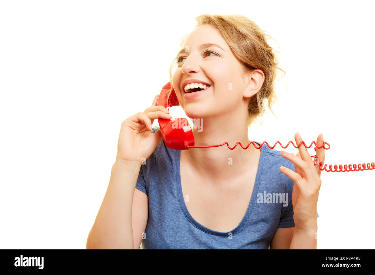 Young woman phoning with customer service advice on landline phone ...
