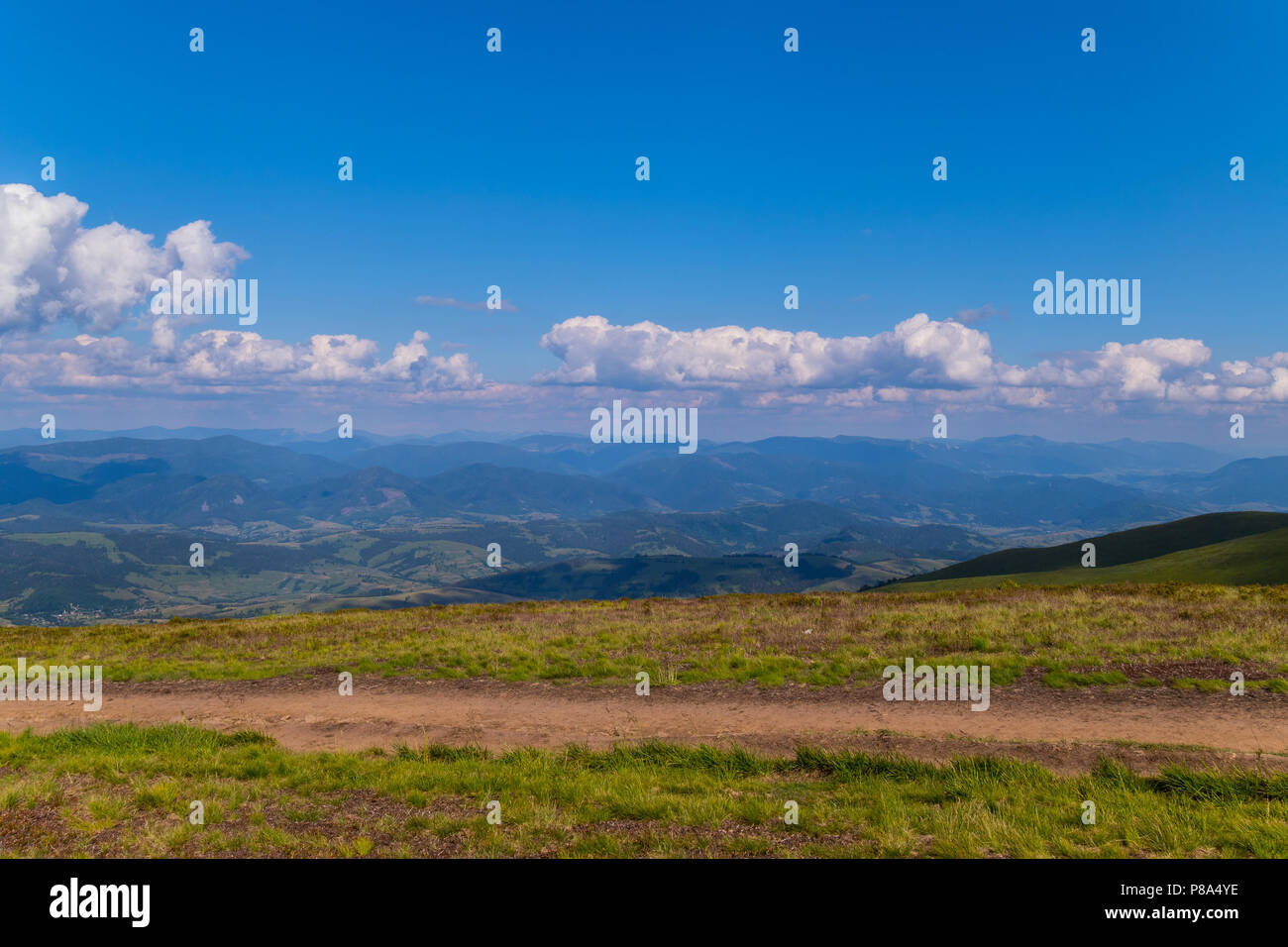 The top view of the huge gently sloping green mountain ranges and the ...