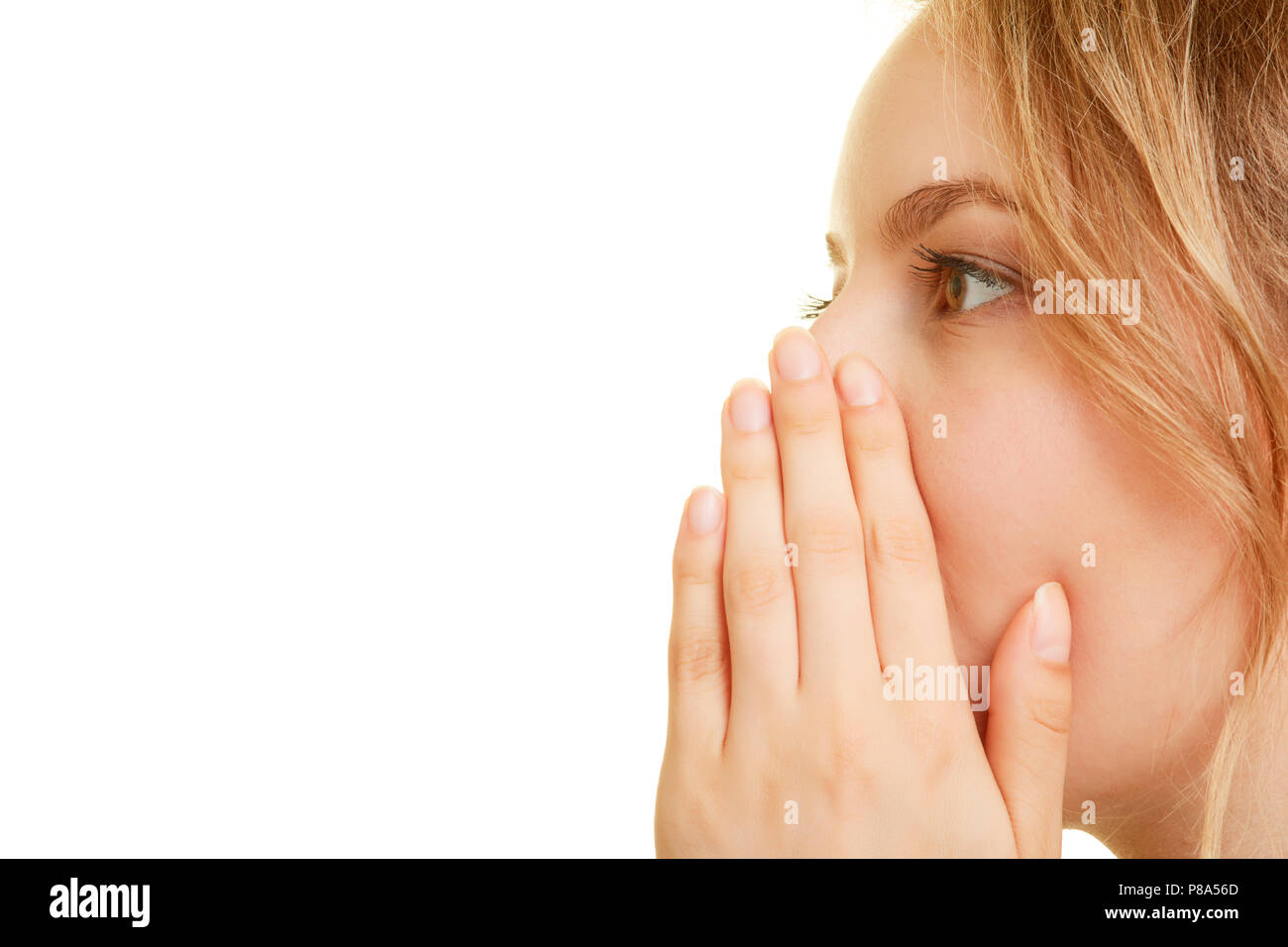 Young woman holds hand to mouth while whispering a secret Stock Photo ...