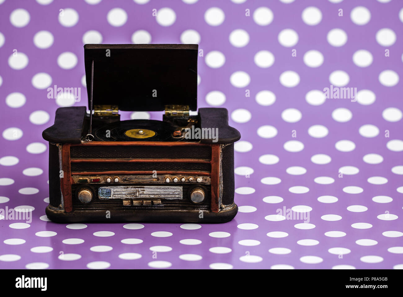 Decorative retro record player on purple background Stock Photo - Alamy