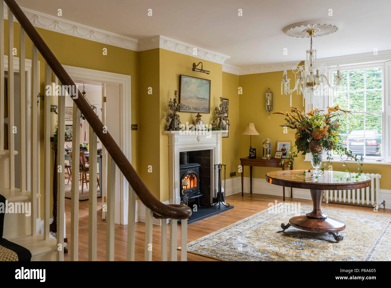 Woodburning stove in fireplace of Regency entrance hallway with ...