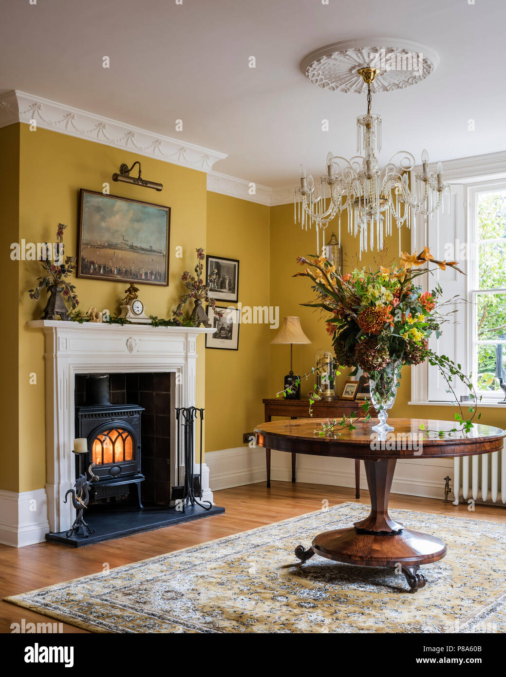 Woodburning stove in fireplace of Regency entrance hallway with ...
