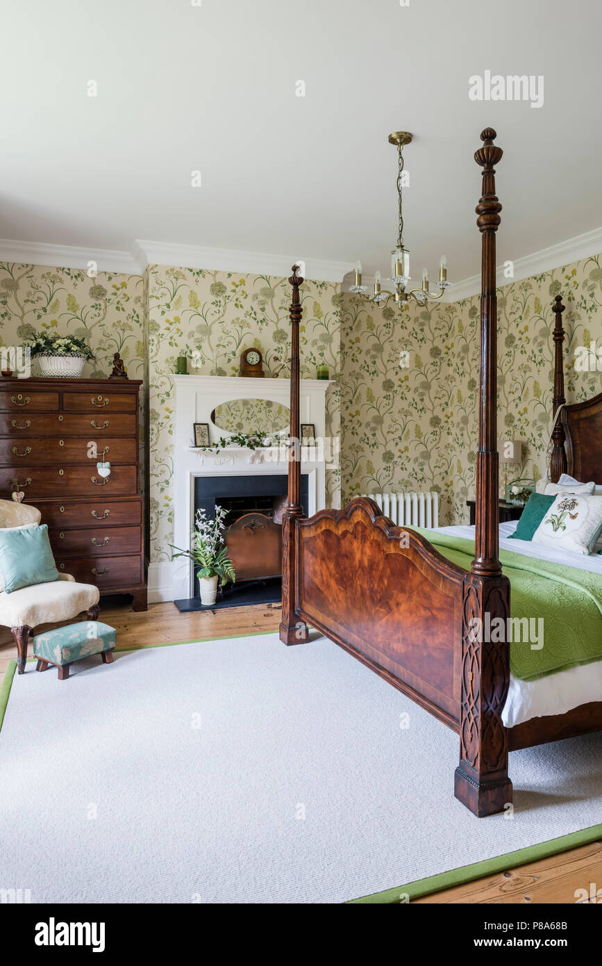 Antique wooden four-poster bed in Regency bedroom with tallboy Stock ...