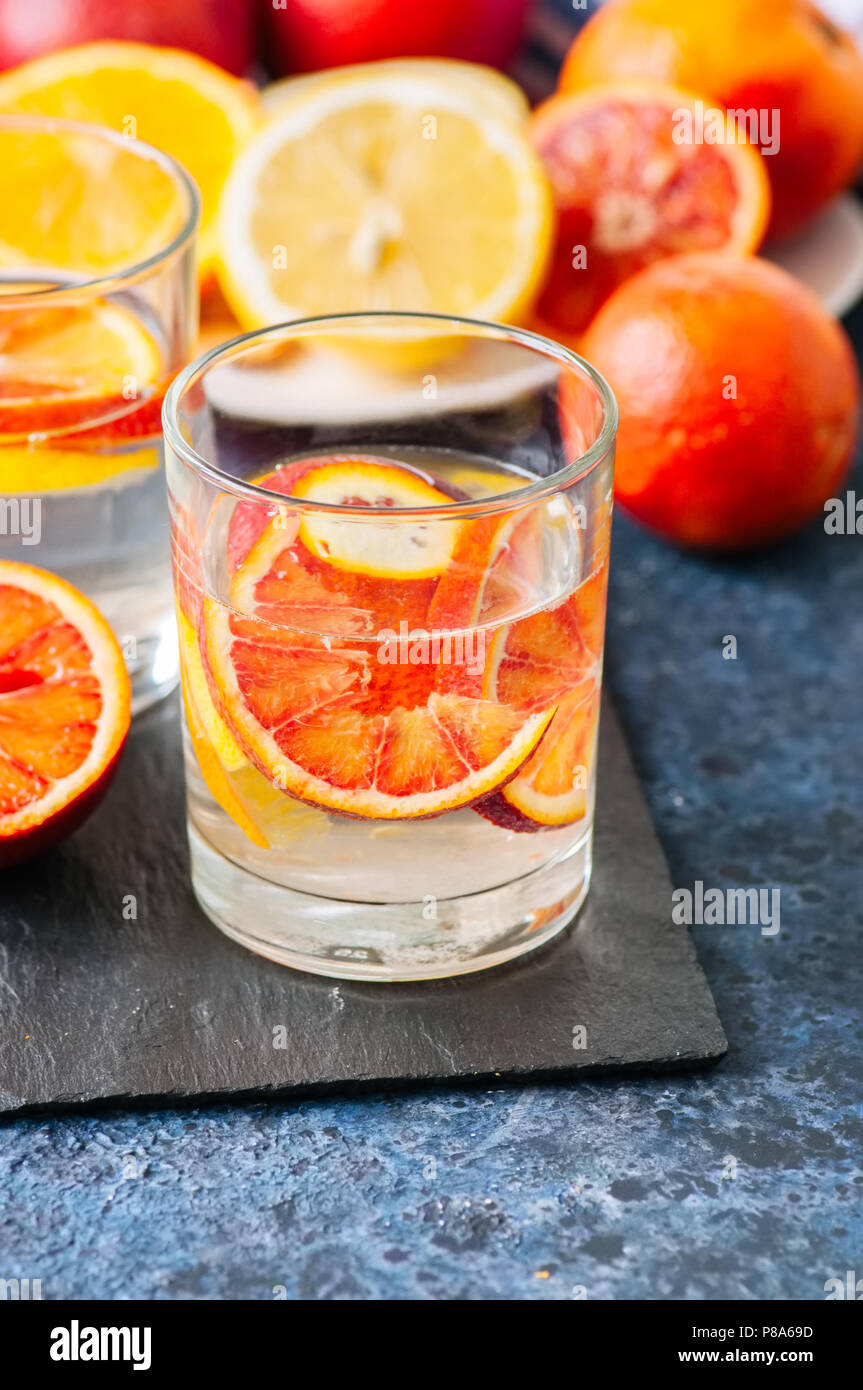 Citrus infused water with slices of fruits. Seasonal beverages concept ...