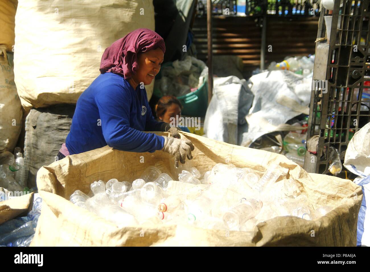 ANGONO, RIZAL, PHILIPPINES - JULY 4 2018: Workers of a materials ...