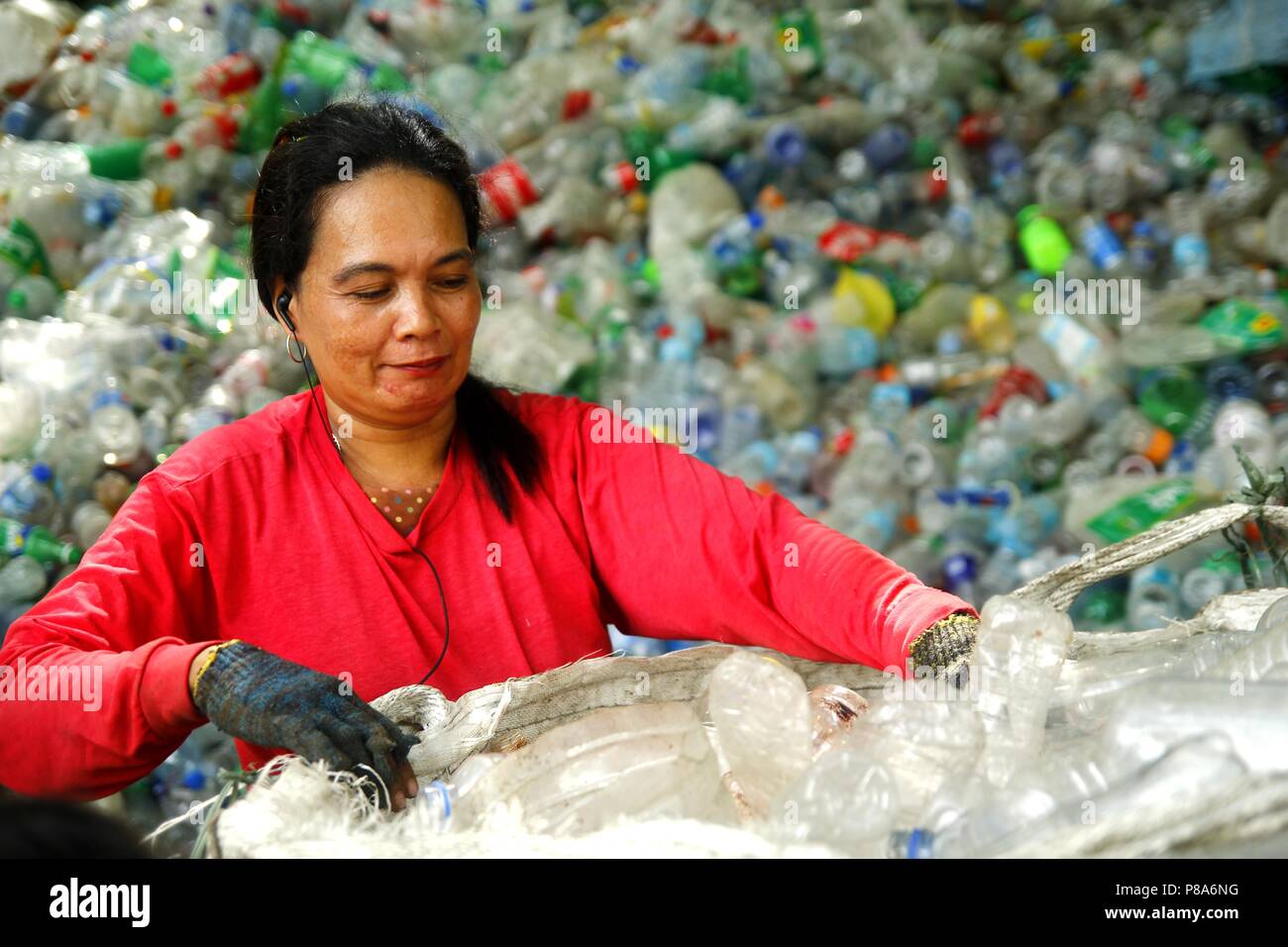 ANGONO, RIZAL, PHILIPPINES - JULY 4 2018: Workers of a materials ...