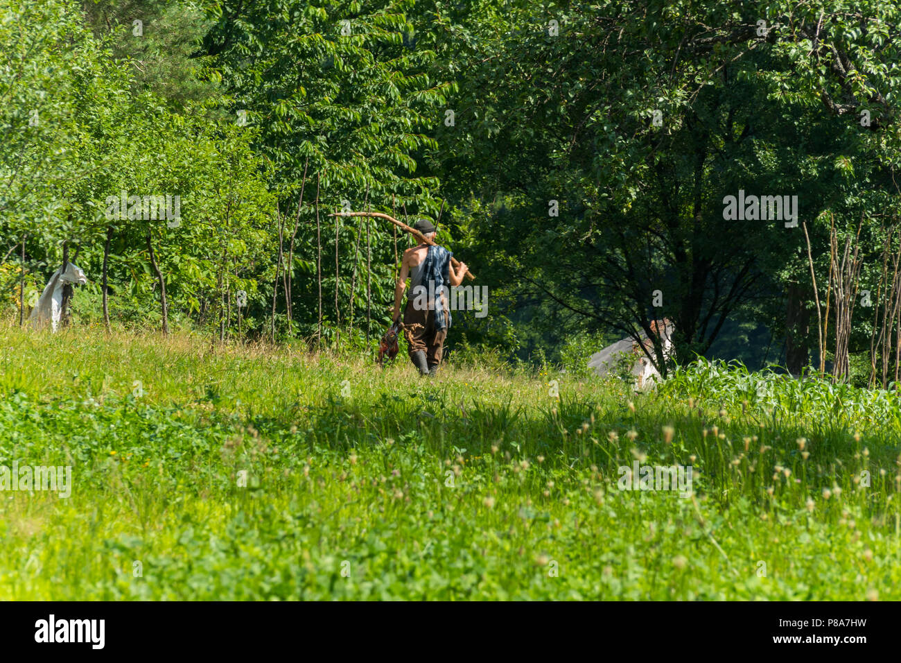 Fisherman in black rubber boots with a catch on the lawn . For your ...