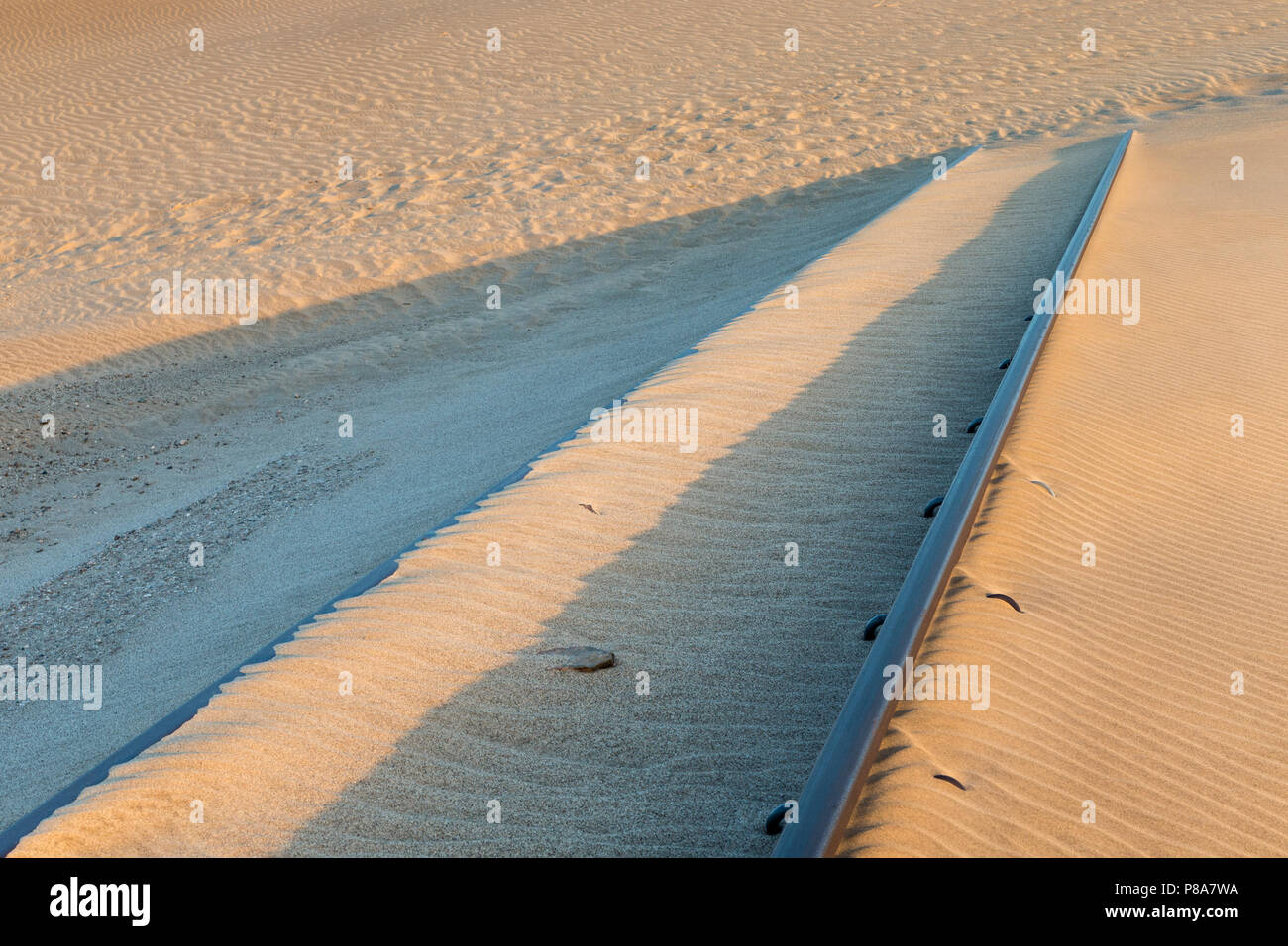 Sand dunes blown across railway line to Lüderitz, Namibia Stock Photo ...