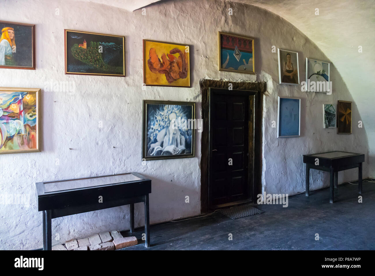 The museum room with several unusual paintings hung on the sides of the ...