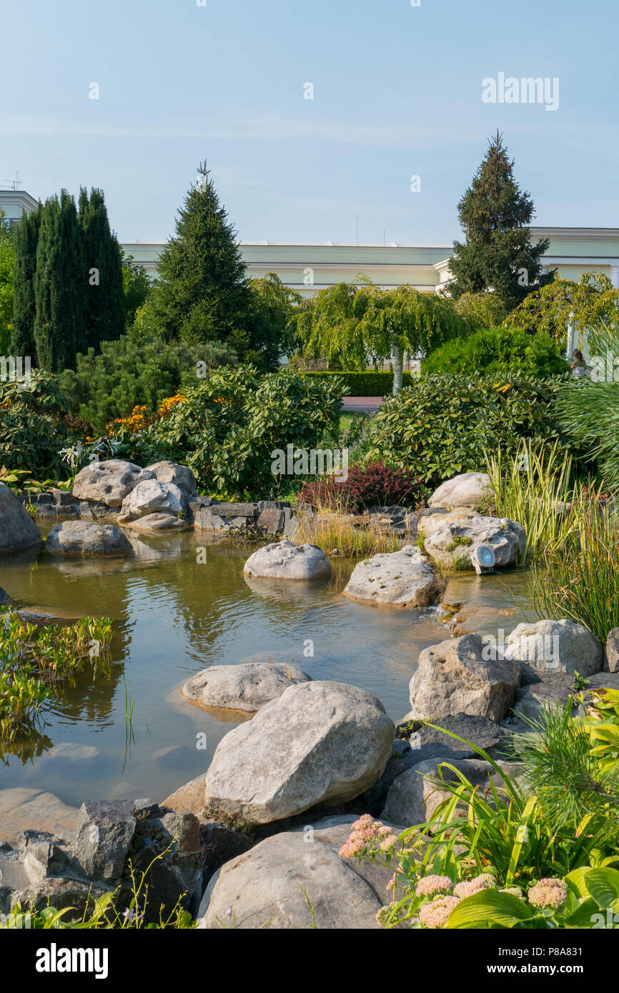 The creek is strewn with large, heavy cobblestones flowing between ...