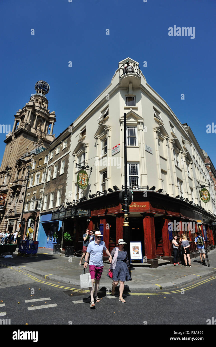 A Couple crossing road & The Chandos Pub in London, England, UK Stock ...