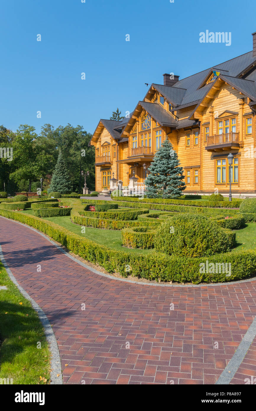 A beautiful house in the park made in a modern style with tiled paths ...