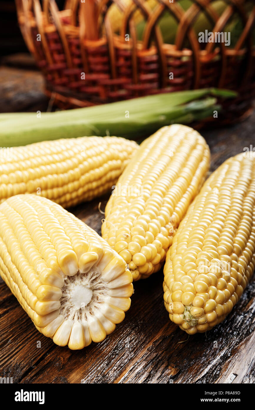 sweet corn on sackcloth, half of corn, some corn peeled, some do not ...