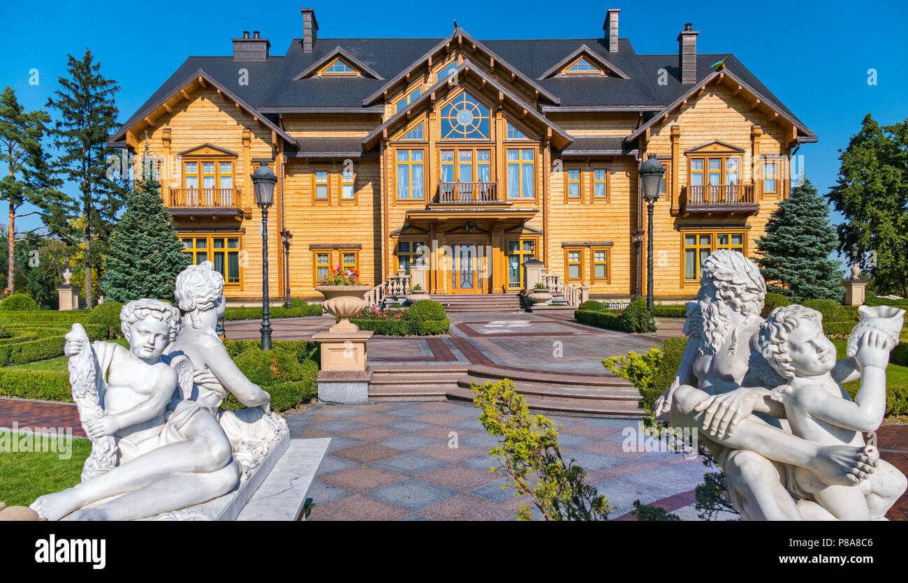 Ancient sculptures at the entrance of a huge wooden building against ...
