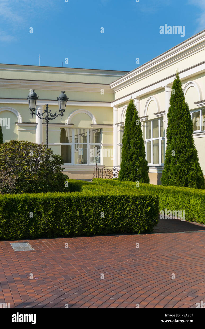 Parked with red tiles, a walking promenade with smoothly cut ornamental ...