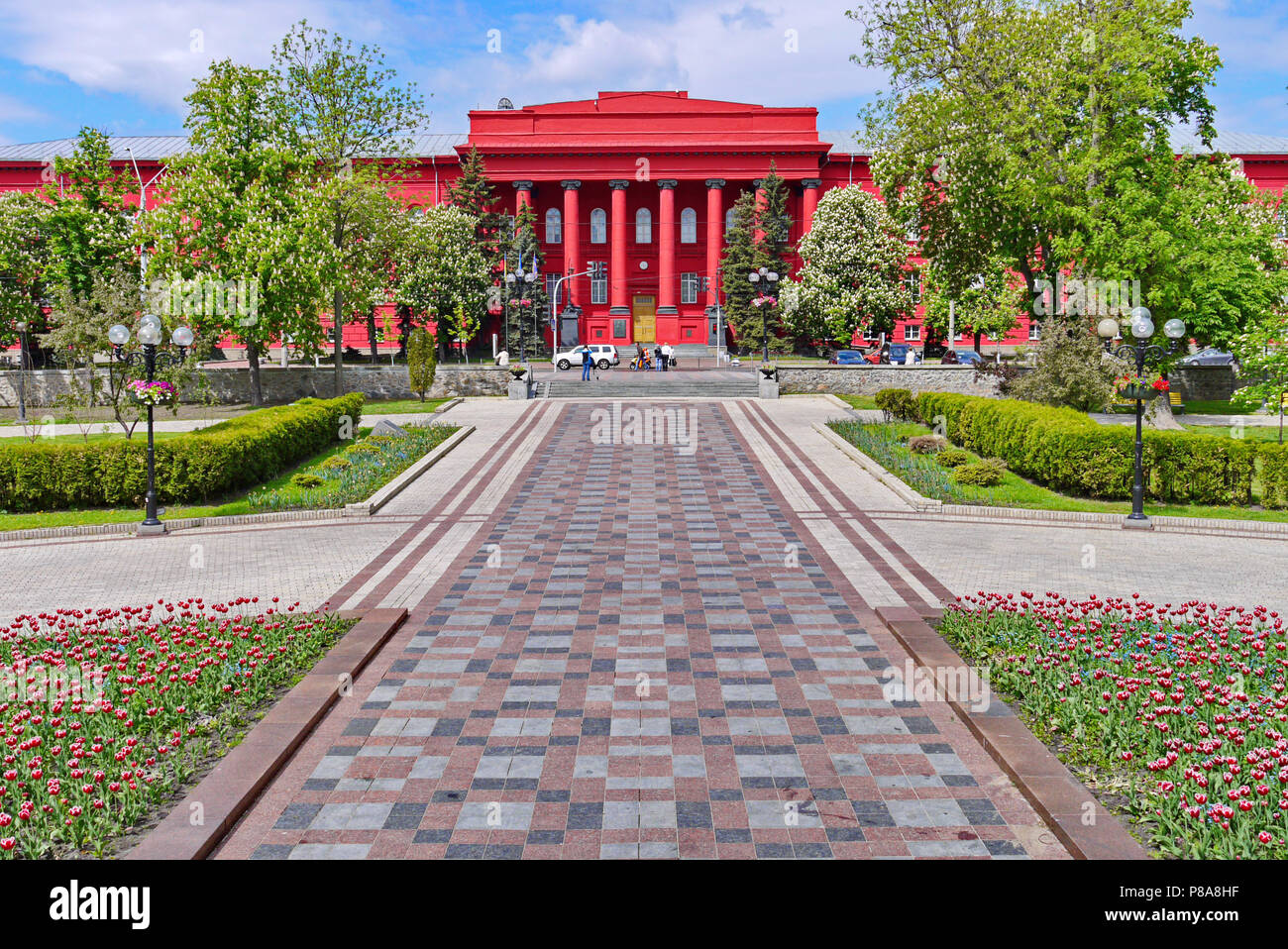 Alley leads to an unusual bright red building with columns . For your ...