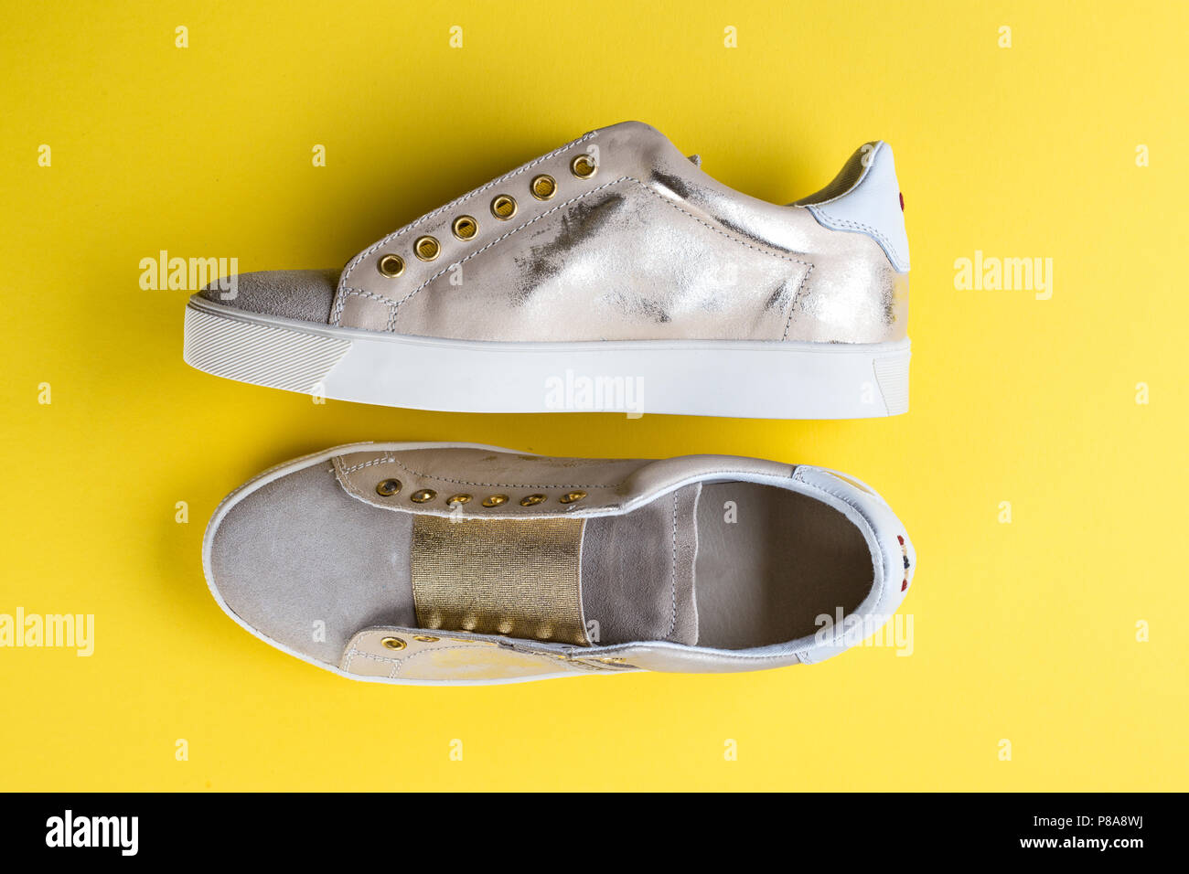 female spring sneakers on a yellow background, space for text Stock ...