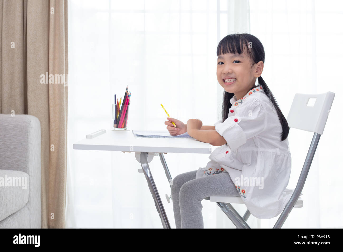 Asian Little Chinese girl doing homework at home Stock Photo - Alamy