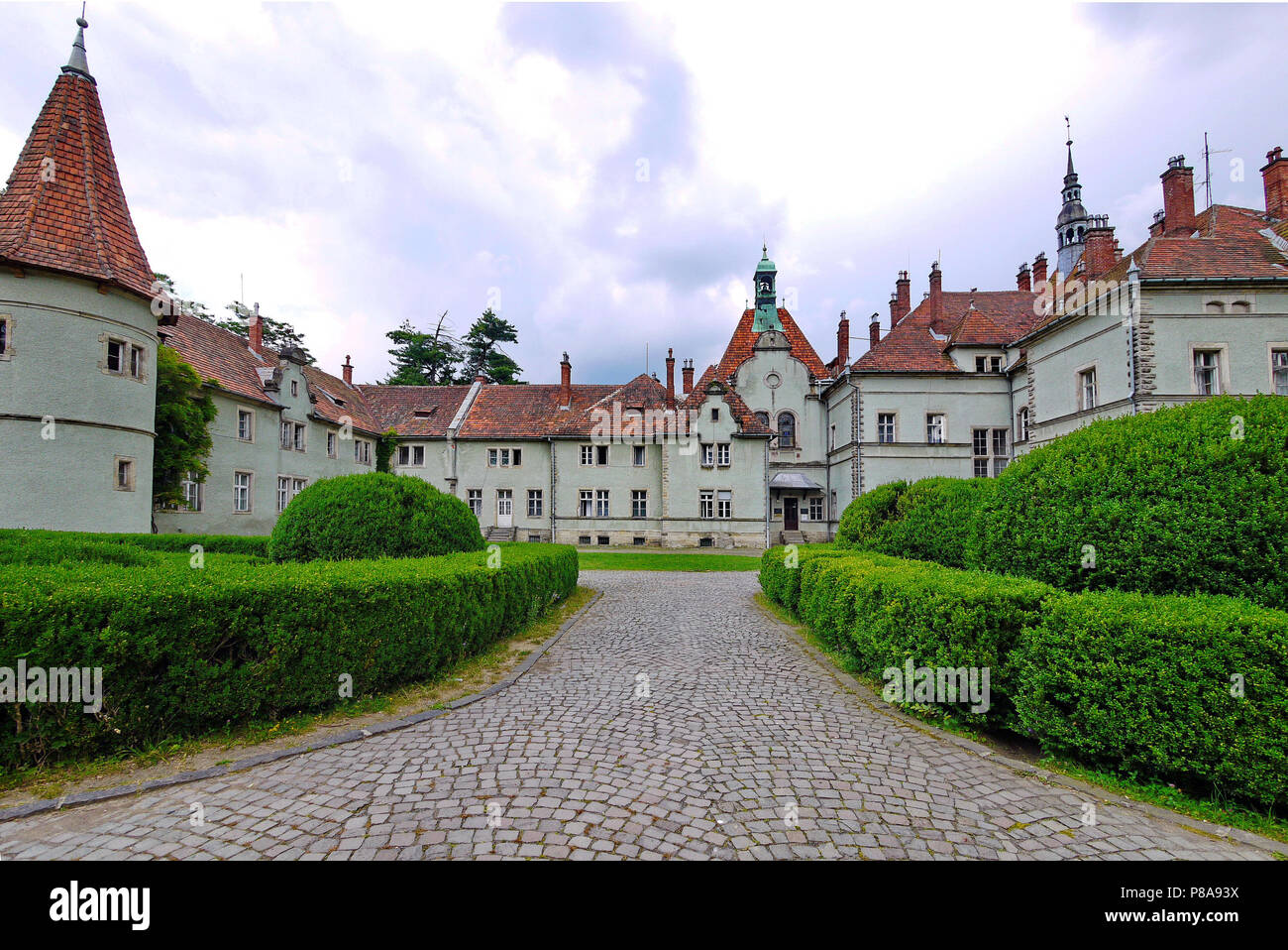 Ancient medieval castle with a red roof on a green park background ...