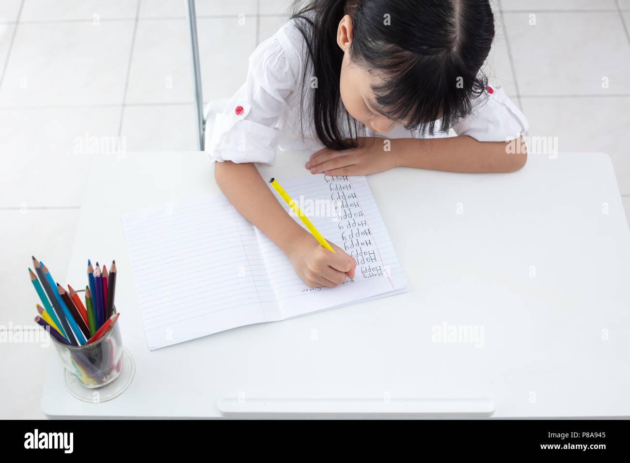 Asian Little Chinese girl doing homework at home Stock Photo - Alamy