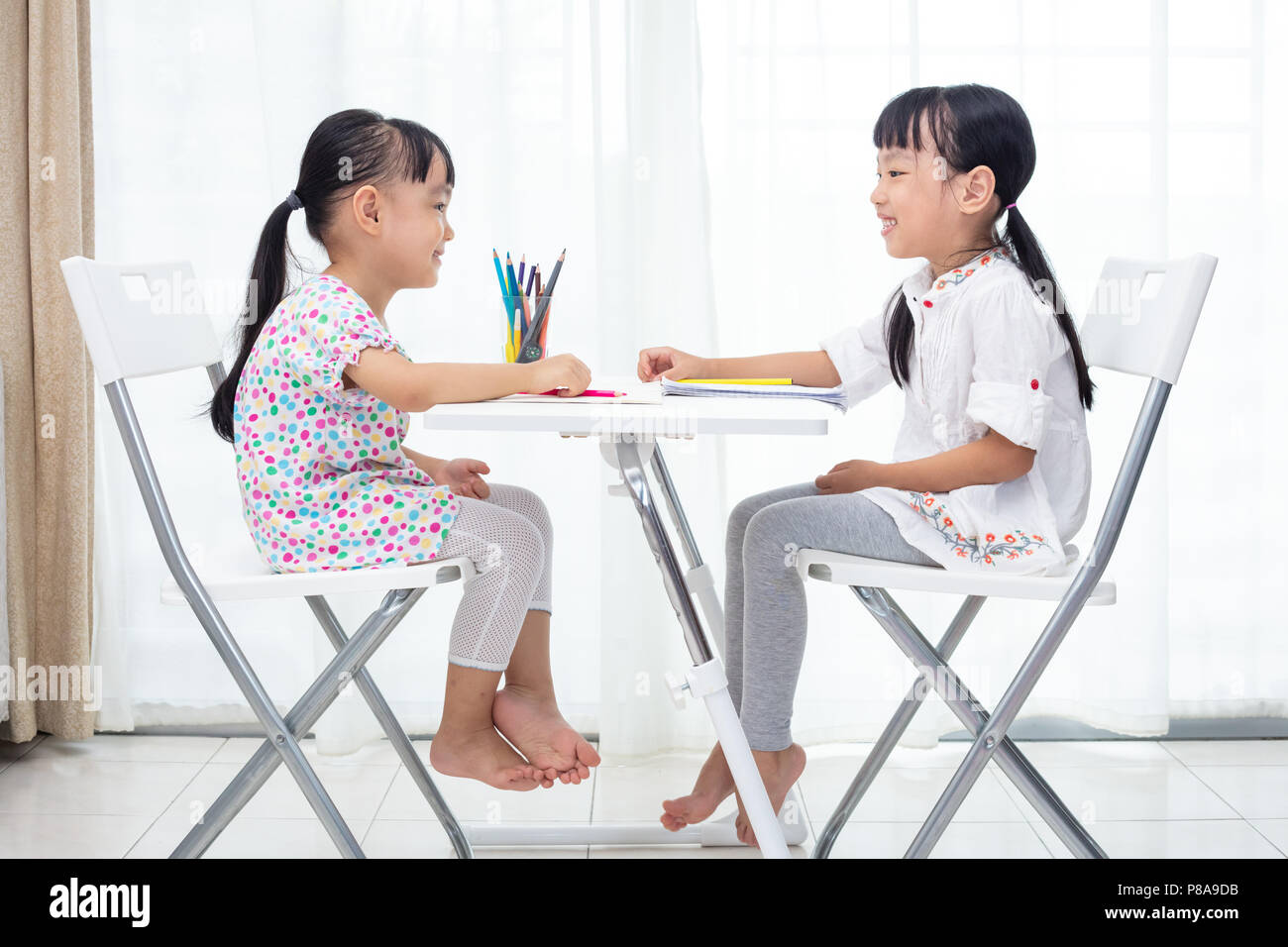 Asian Little Chinese sisters doing homework at home Stock Photo - Alamy