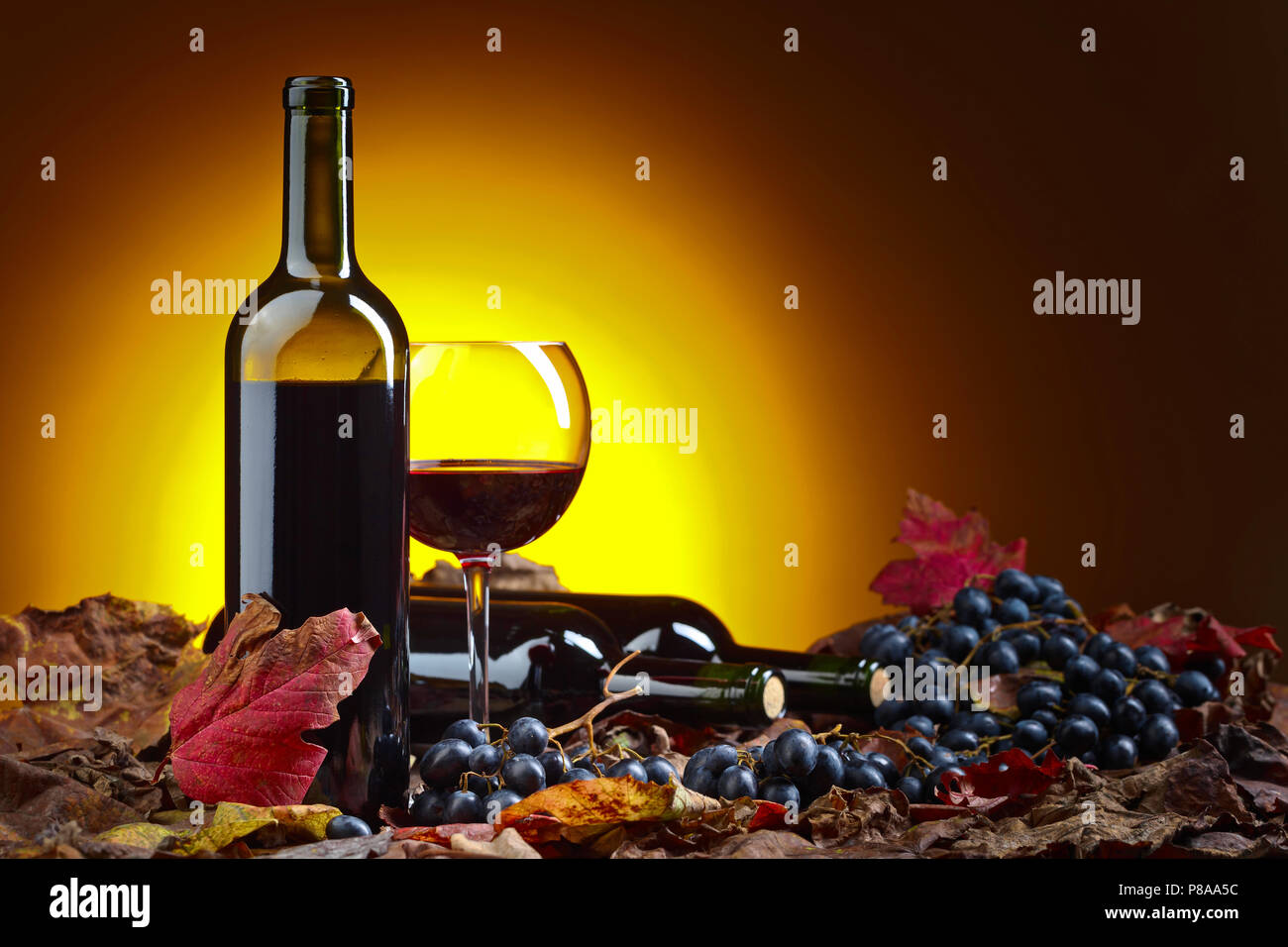 Red wine , grapes and dry vine leaves Stock Photo - Alamy