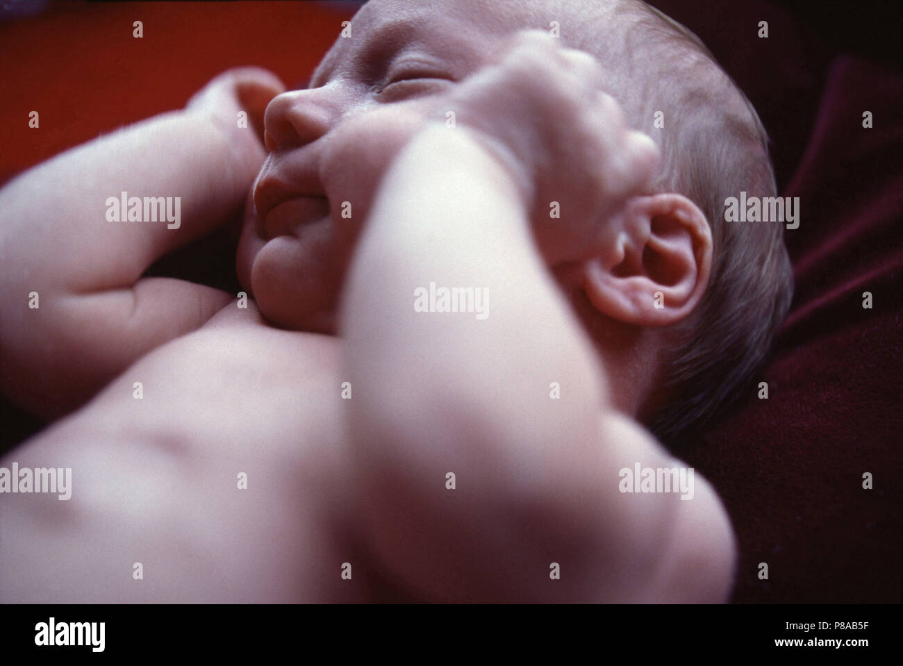 A newborn baby boy sleeps after being brought home from the hospital ...