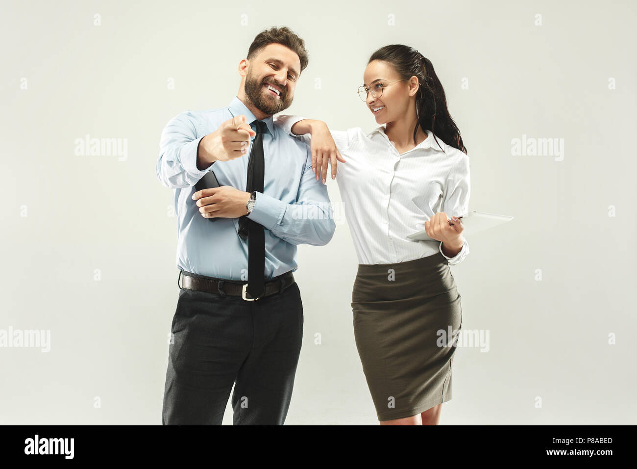 Happy boss. Man and his secretary standing at office Stock Photo - Alamy