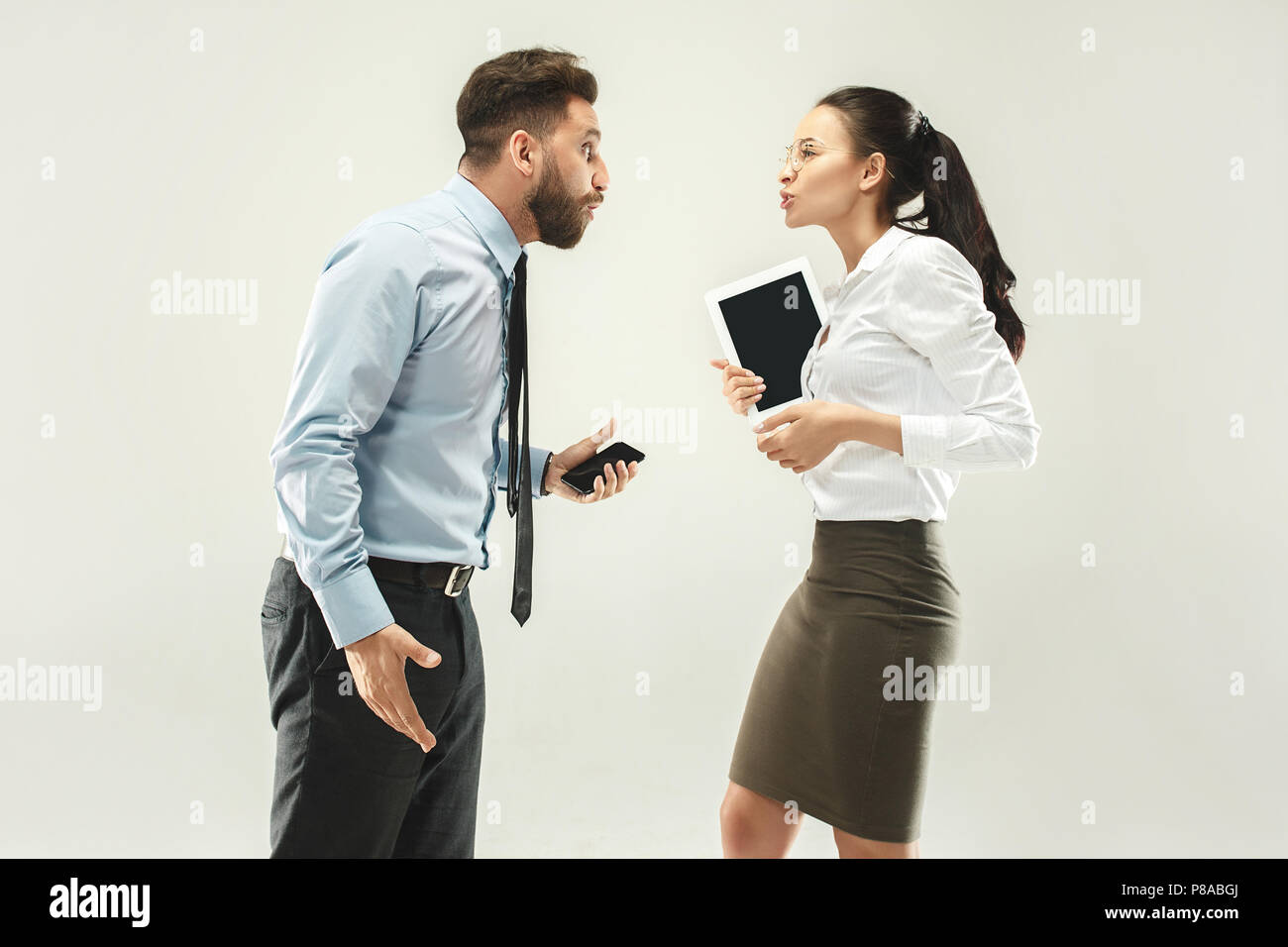 Angry boss. Man and his secretary standing at office or studio Stock ...