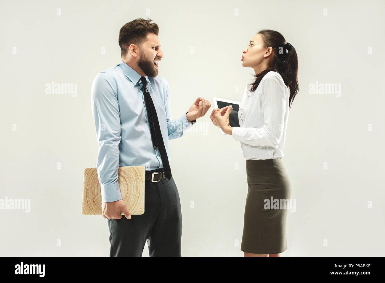 Angry boss. Man and his secretary standing at office or studio Stock ...