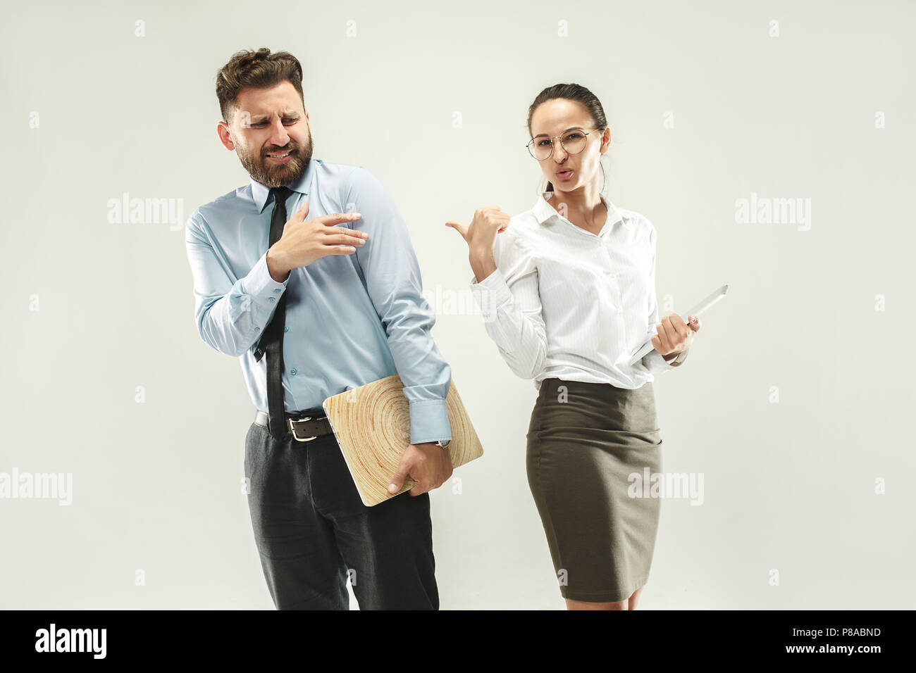 Angry boss. Man and his secretary standing at office or studio Stock ...