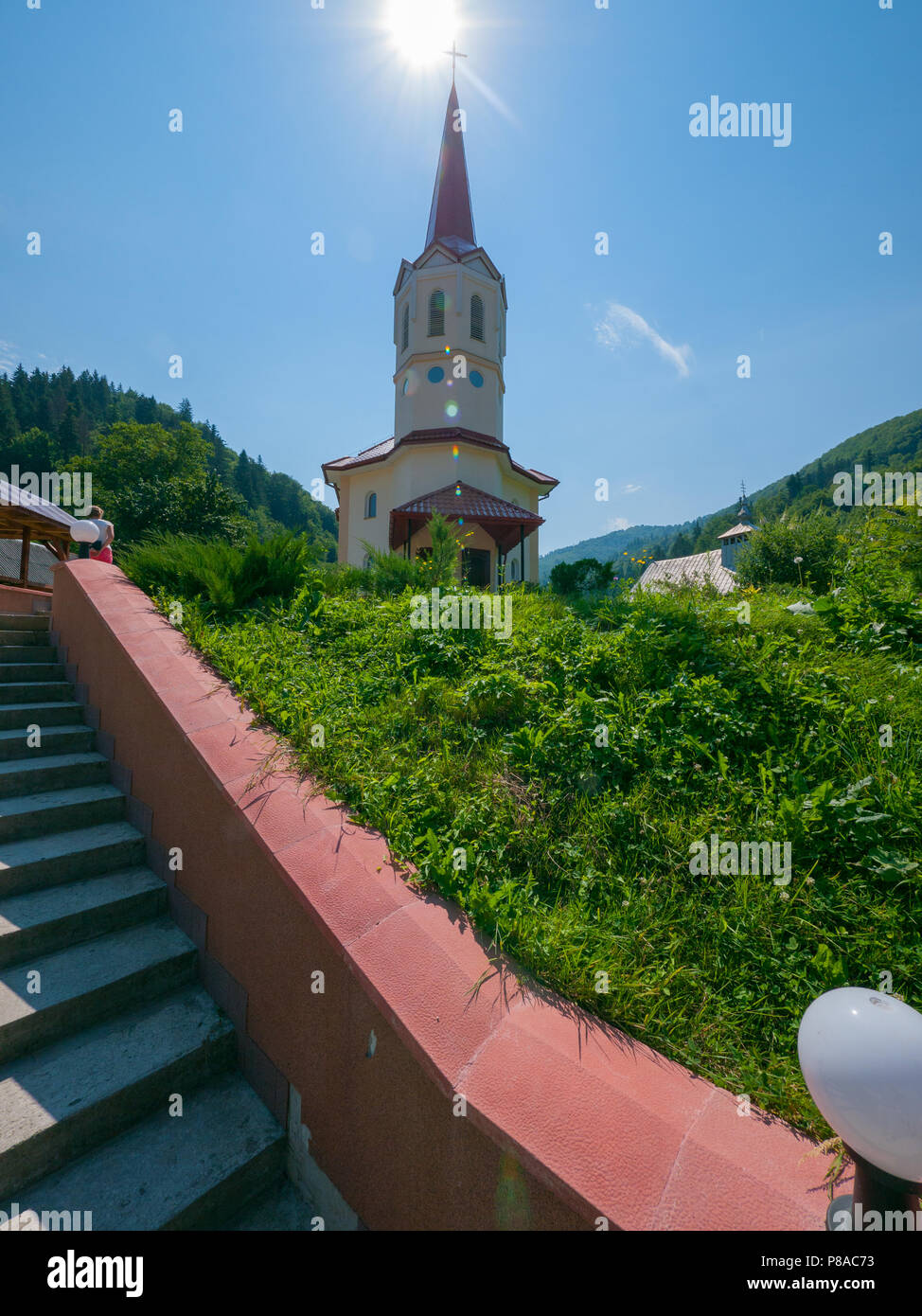 Steps of the stairs leading up to the church with a high pointed roof ...